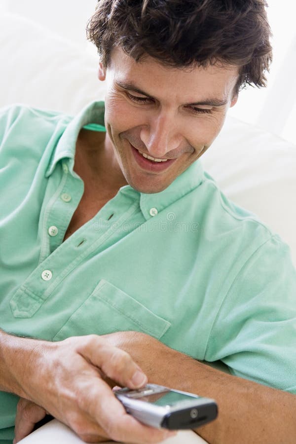 Man indoors text messaging stock photo. Image of couch - 5934654