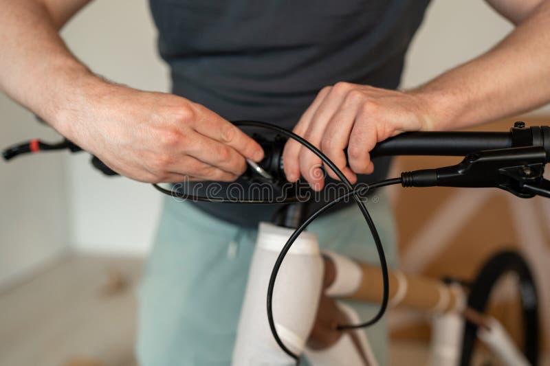 A Man is Inside Working on Assembling Bike Handlebars As Part of His ...