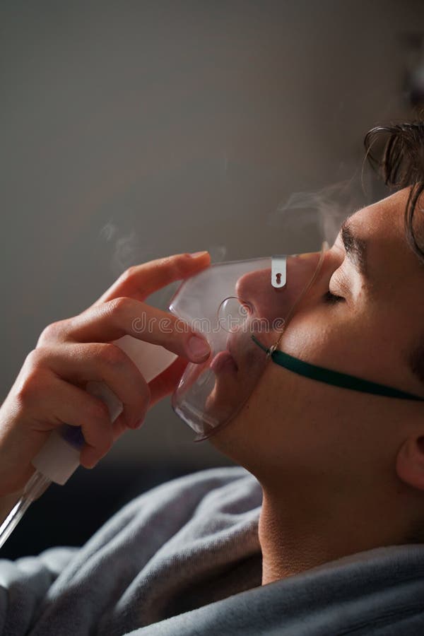 Man Inhaling through Oxygen Mask for Cough Treatment. Using Compressor ...