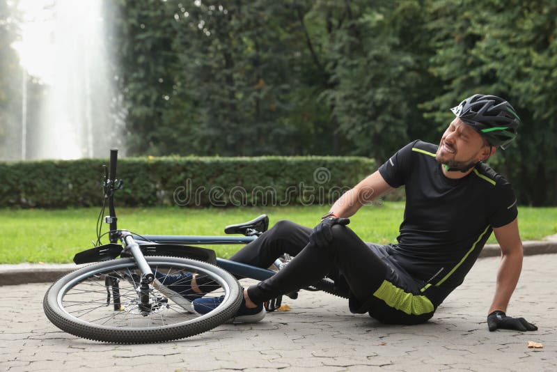 Man with Injured Knee Near Bicycle Outdoors Stock Photo - Image of ...