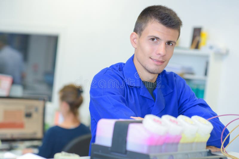 Man and ink containers stock photo. Image of edit, male - 314280824