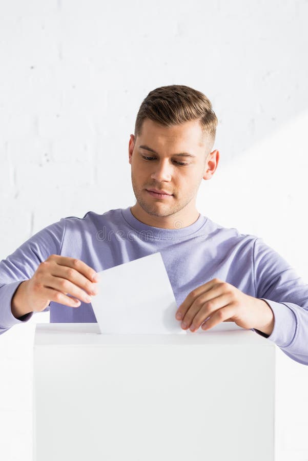 Man Inserting Ballot into Polling Booth Stock Image - Image of choose ...