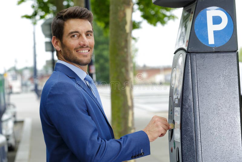 Man Inserting Coin for Parking Ticket in Parking Machine Stock Photo ...