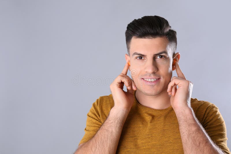 Man Inserting Foam Ear Plugs Grey Background Stock Photos - Free ...