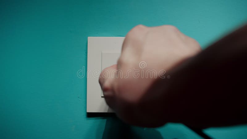 Man Inserts Plug into Electrical Socket on a Blue Wall Stock Video ...