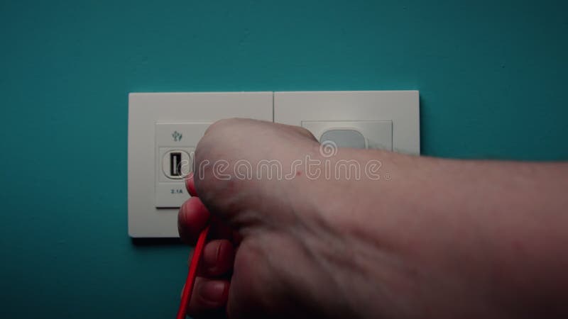 Man Inserts Plug into Electrical Socket on a Blue Wall Stock Video ...
