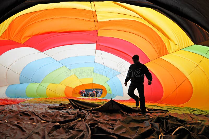 Man Inside a Colorful Hot Air Balloon Inflating Stock Image - Image of ...