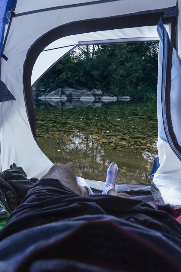 Man Inside a Tent Overlooking the River. Beautiful Scenery in a Camp ...