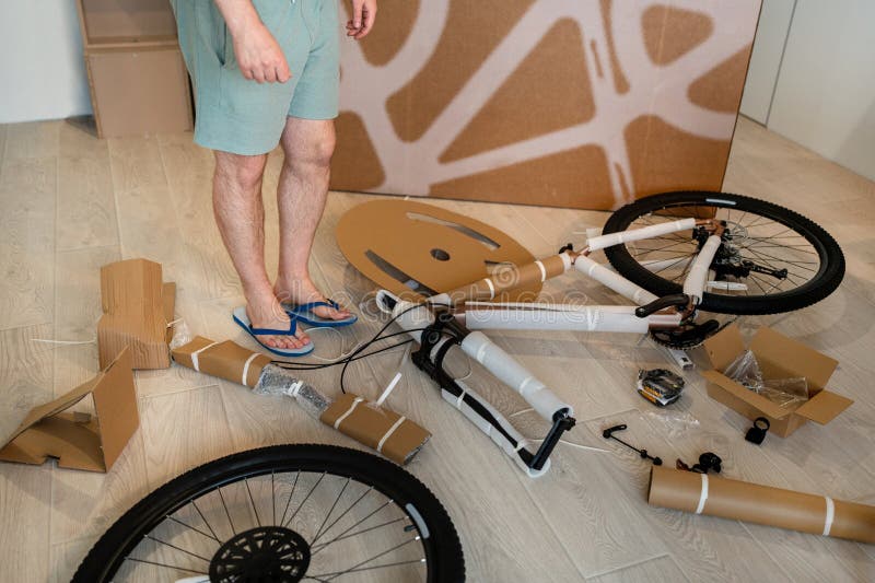 A Man is Inside Working on Assembling Bike Handlebars As Part of His ...