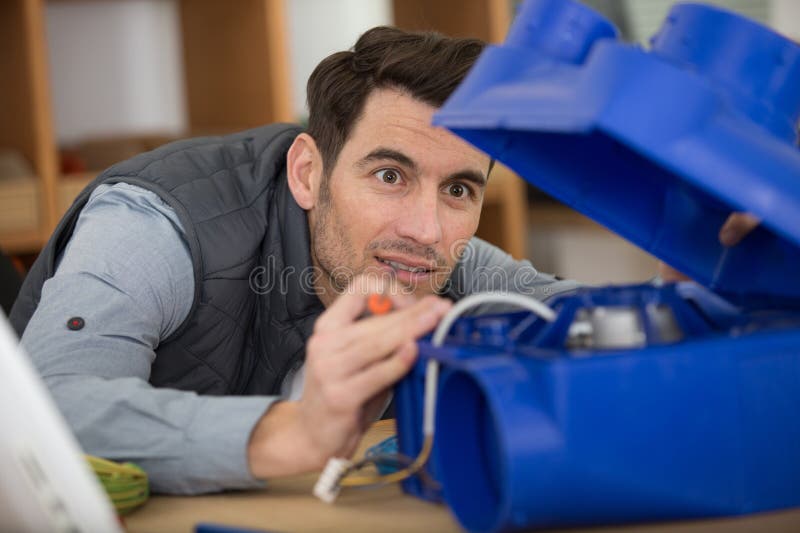 Man Inspecting Blue Plastic Box Housing Electrical Component Stock ...