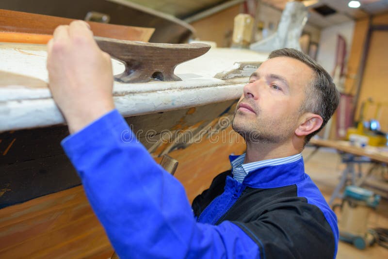 Man inspecting boat stock image. Image of carpenter - 298847947