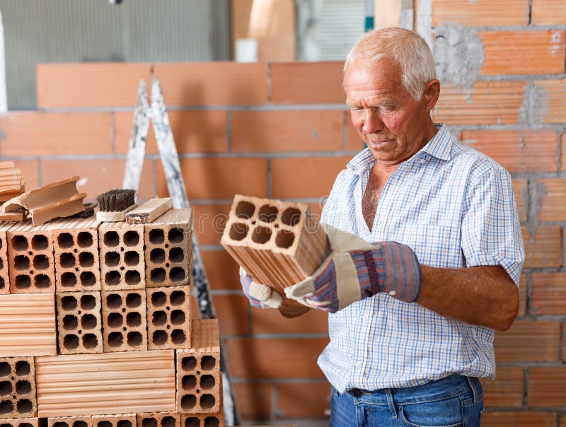 Man Inspecting Brick for Installing Wall Stock Image - Image of masonry ...