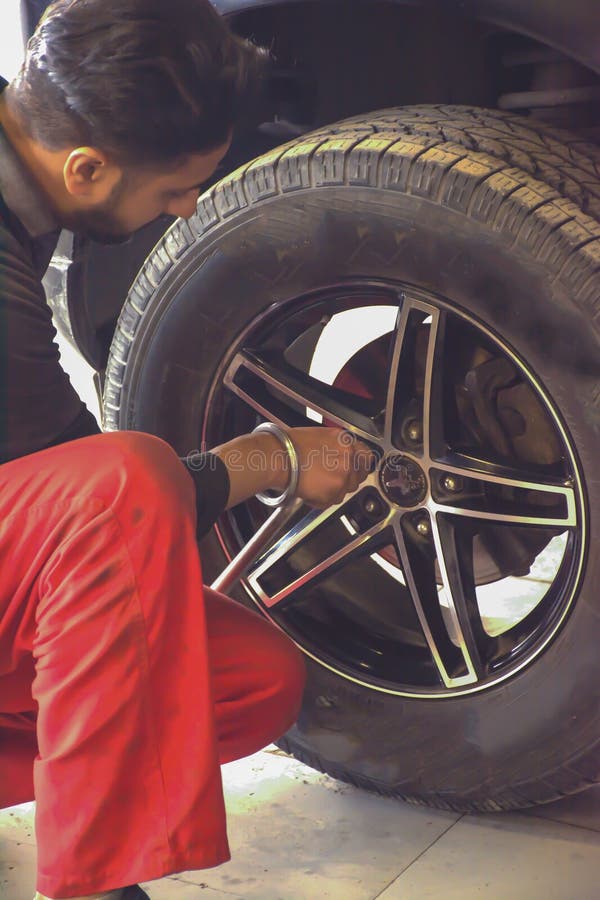 Man Servicing Car and Opening the Tyre of the Car Editorial Stock Photo ...