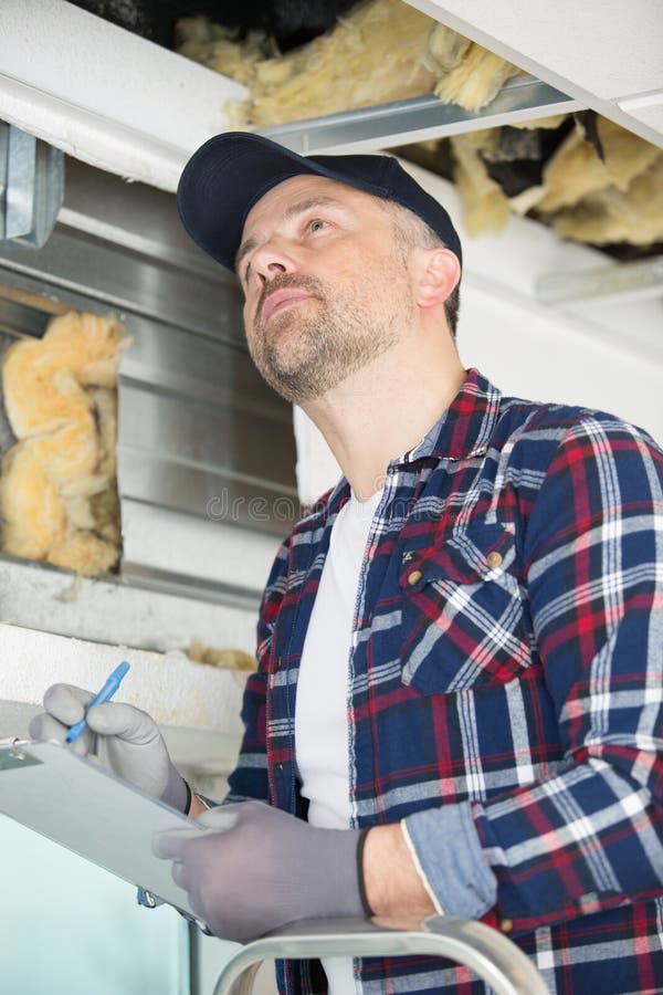 Man Inspecting Insulation in Building Stock Photo - Image of ...