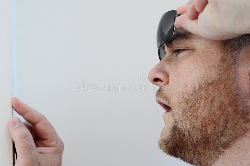 Man Inspecting Wall stock photo. Image of sunglasses - 14390558