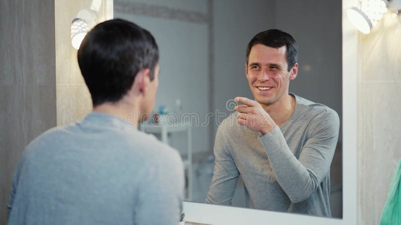 Man Inspires Himself in Front of a Mirror Stock Video - Video of ...