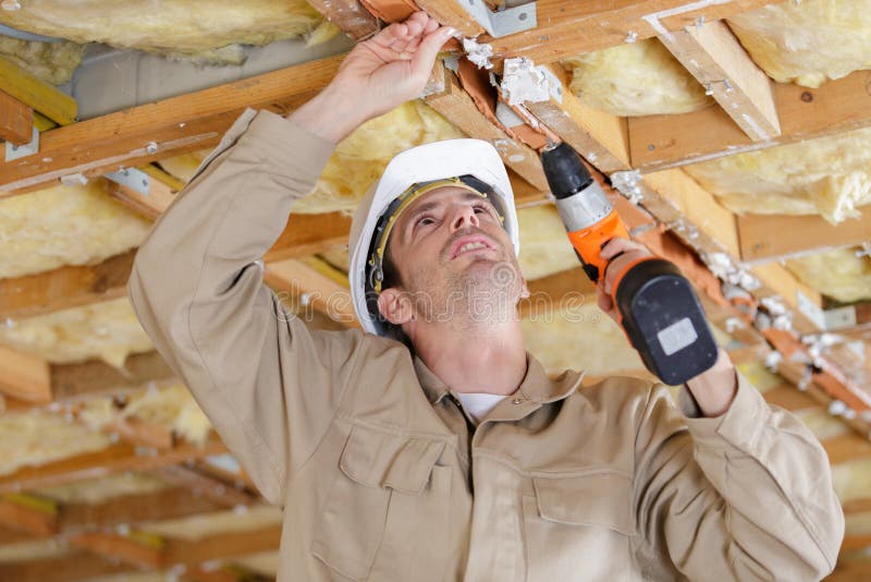 Man installing ceiling stock photo. Image of blueprint - 264988202