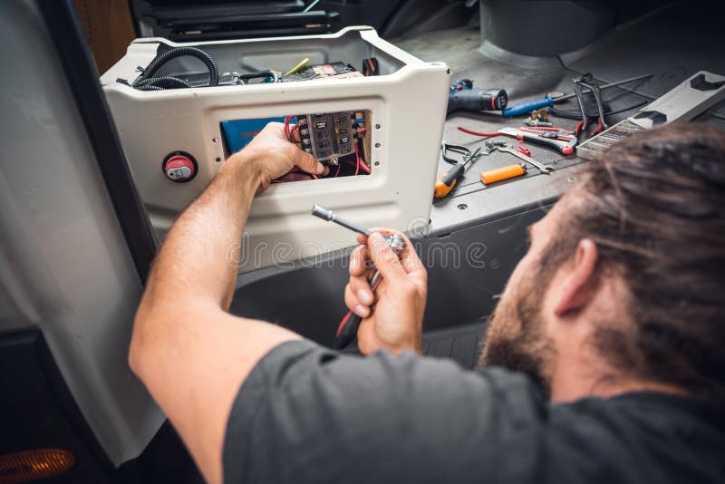Man Installing Electrical Equipment in His DIY Camper Van Stock Photo ...