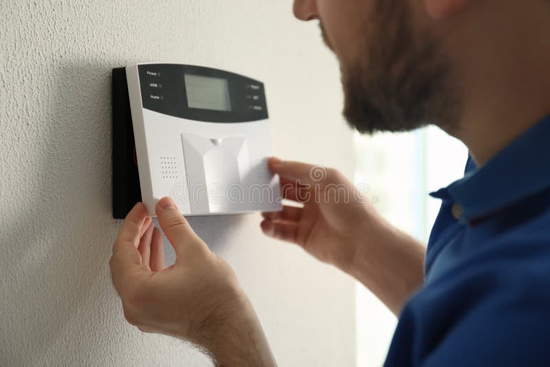 Man Installing Home Security System on White Wall in Room, Closeup ...