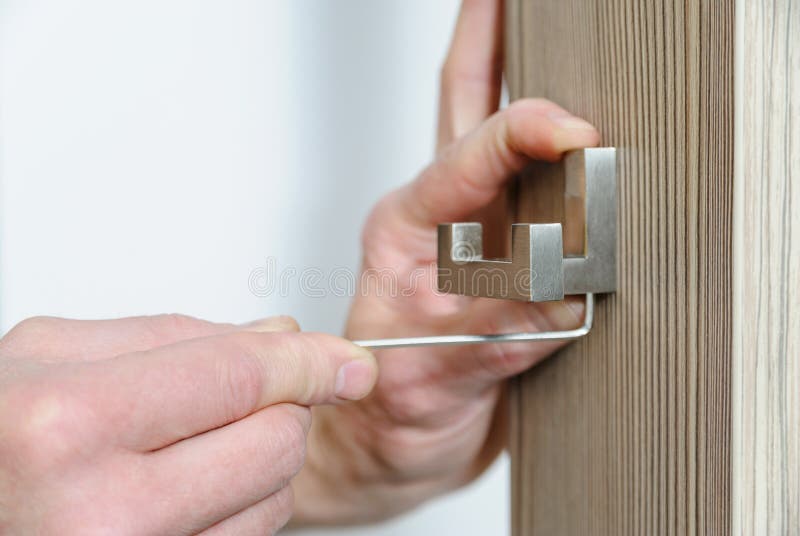 A Man is Installing a Hook. Stock Image - Image of clothes, steel ...