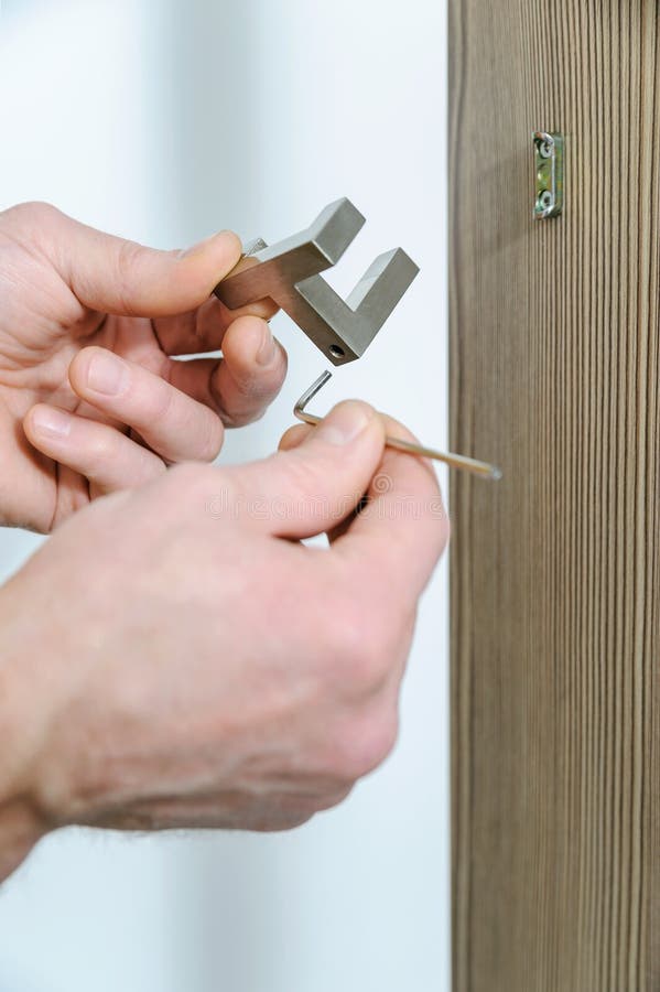 A Man is Installing a Hook. Stock Photo - Image of repair, material ...