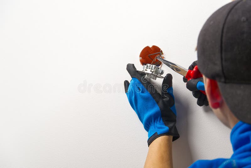 Electrician Installing Light Switch on Painted Wall with Screwdriver ... Electrician Installing Light Switch on Painted Wall with Screwdriver ...