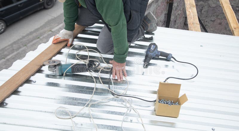 Man Installing Metal Sheet Roof by Electrical Drilling Machine Stock ...