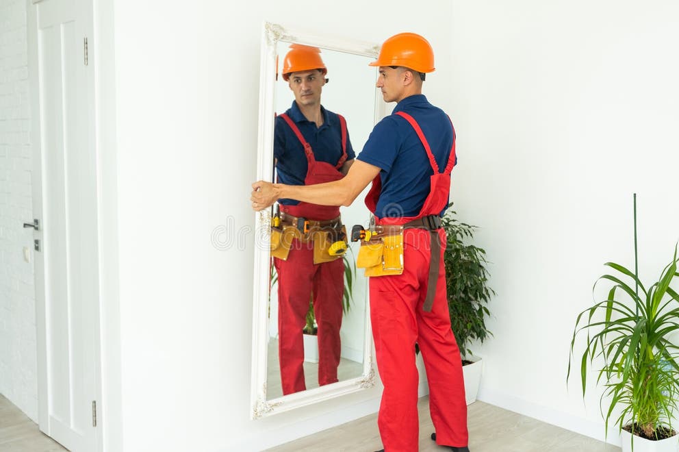 Man Installing a Mirror on Wall Stock Photo - Image of house ...