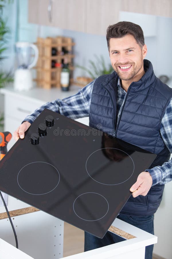 Man Installing New Induction Hob in Modern Kitchen Stock Photo - Image ...