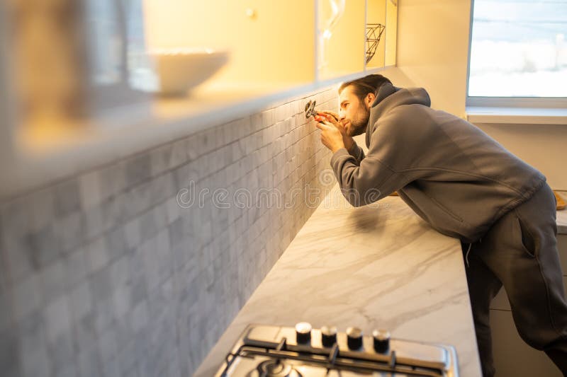 Man Installing the Power Socket on the Kitchen Wall Stock Image - Image ...