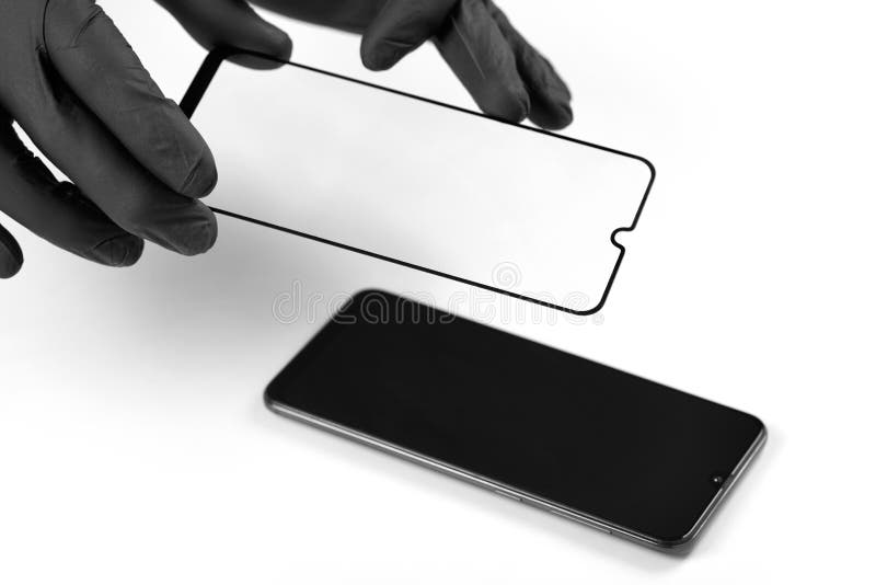 A Man is Installing a Protective Glass on the Smartphone Stock Photo ...