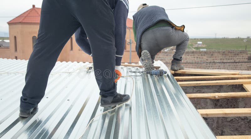 Man Installing of Sheets of Metal Tiles of Roof Stock Photo - Image of ...