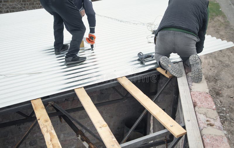 Man Installing of Sheets of Metal Tiles of Roof Stock Image - Image of ...