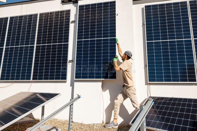 Man Installing Solar Panels on a Rooftop Stock Photo - Image of house ...