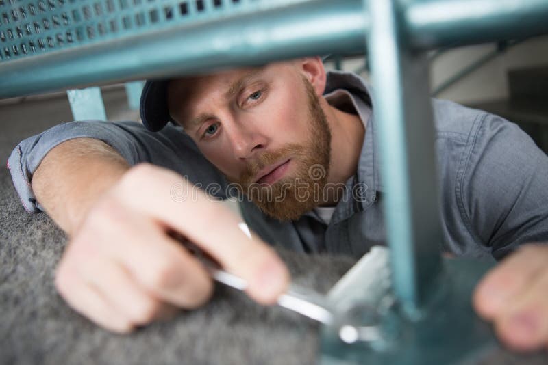 Man Installing Something with Tools Stock Image - Image of board ...