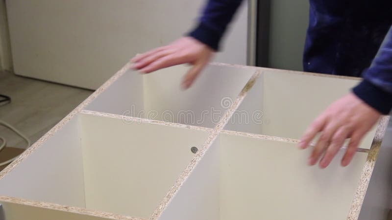 A Man Installs a Block of Shelves into the Body of the Rack. Wooden ...