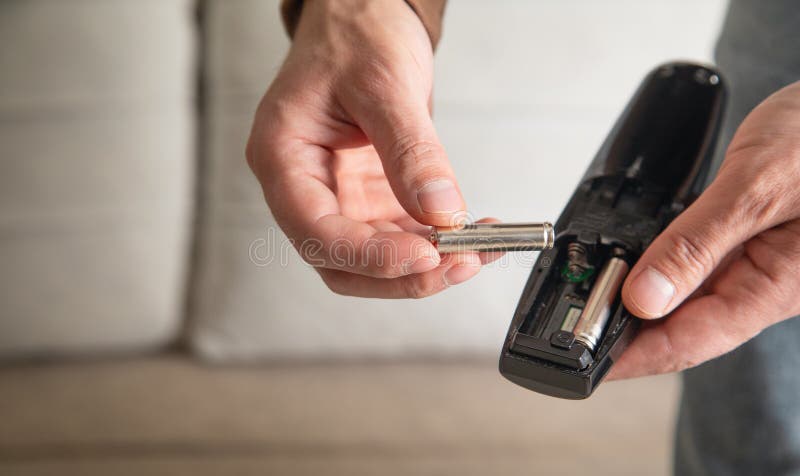 Man Installs a New Battery in the Remote Control of a TV Stock Photo ...