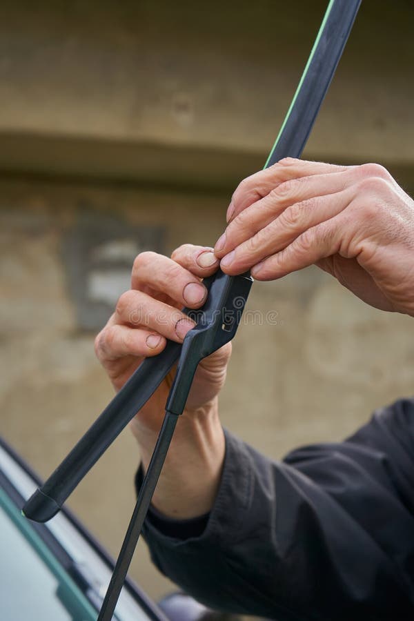 Man Installs the Windshield Wipers of the Car, a Man S Hands Install a ...