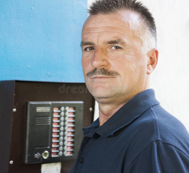 Man and intercom stock photo. Image of handyman, gate - 60686288