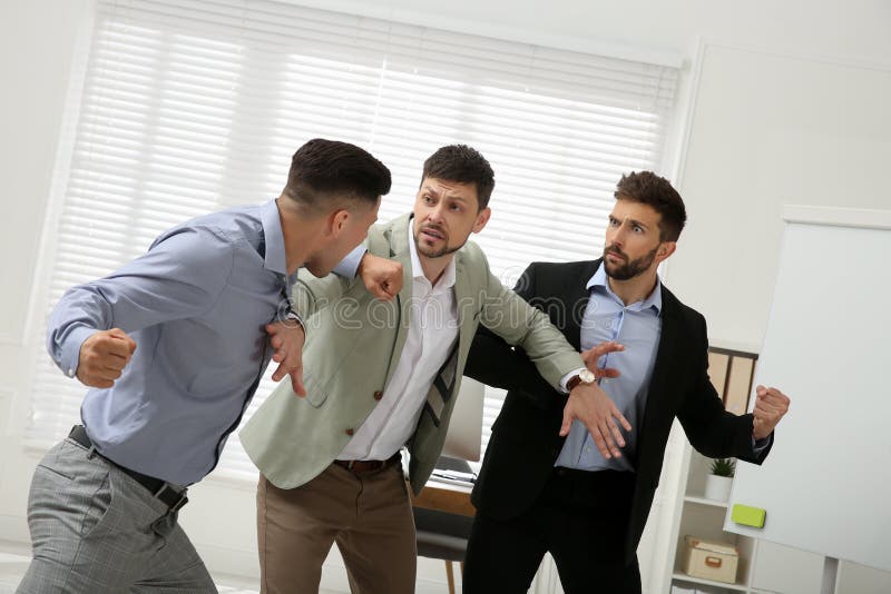 Man Interrupting Colleagues Fight at Work in Office Stock Photo - Image ...
