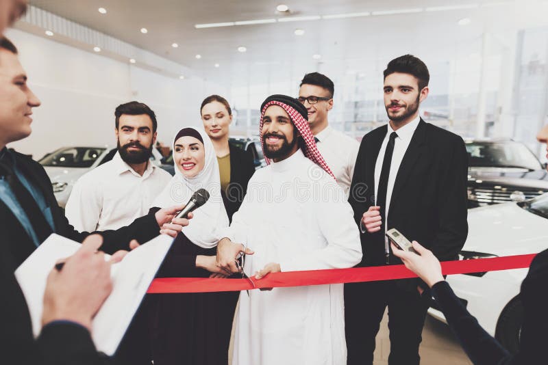 A Man Interviews an Arab Who Cuts the Tape. Stock Photo - Image of ...
