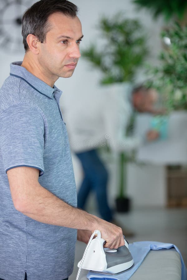 Man Ironing Shirt on Iron Board at Home Stock Photo - Image of linen ...