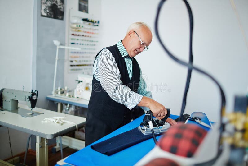 Man ironing stock photo. Image of needlework, mature - 77603976