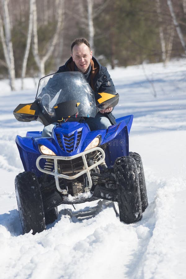 A Man in Jacket Riding Snowmobile in the Winter Forest Stock Image ...