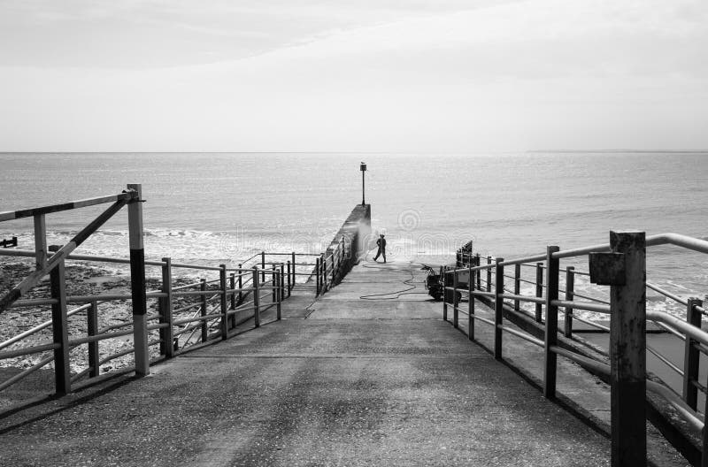 A Man Jet Washes a Jetty on the Sea Front on the West Cliff in Ramsgate ...