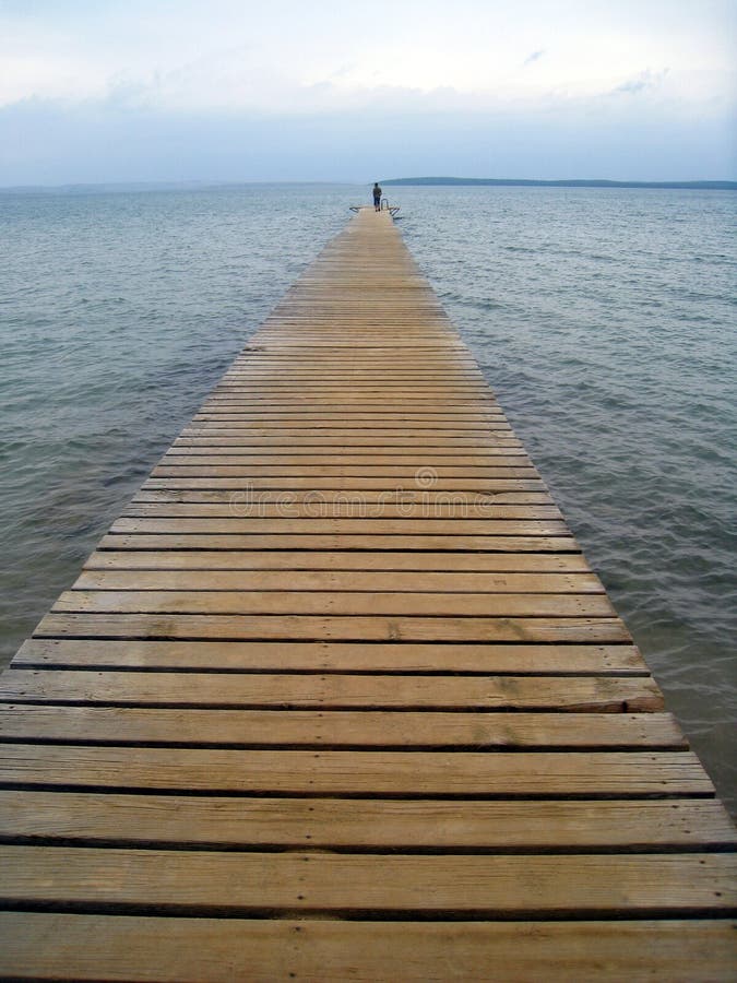 Man on the jetty 1 stock image. Image of beach, green - 17374321