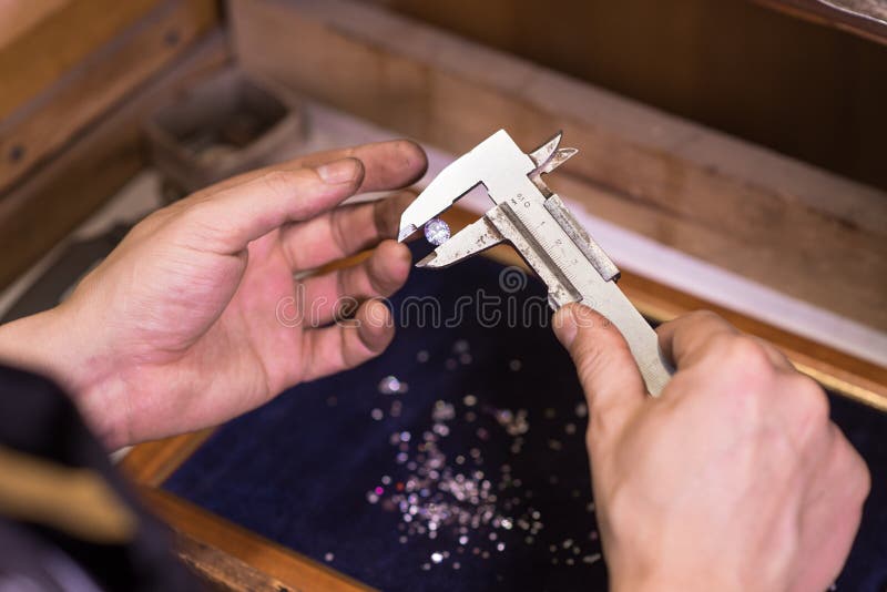 A Man Jeweler Makes an Accurate Measurement of a Gem Using a Caliper ...