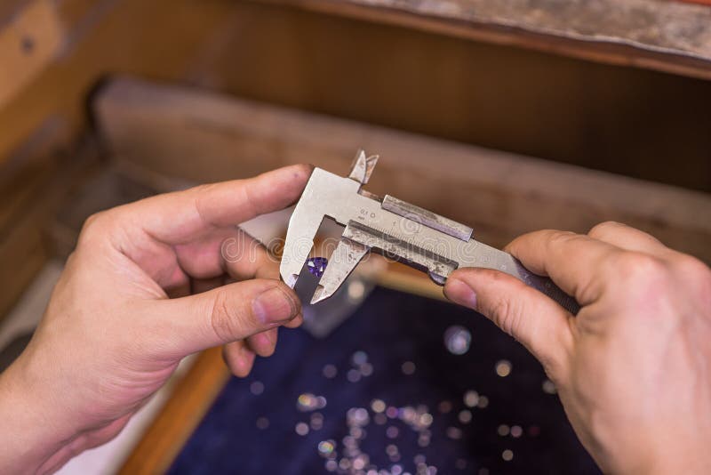 A Man Jeweler Makes an Accurate Measurement of a Gem Using a Caliper ...