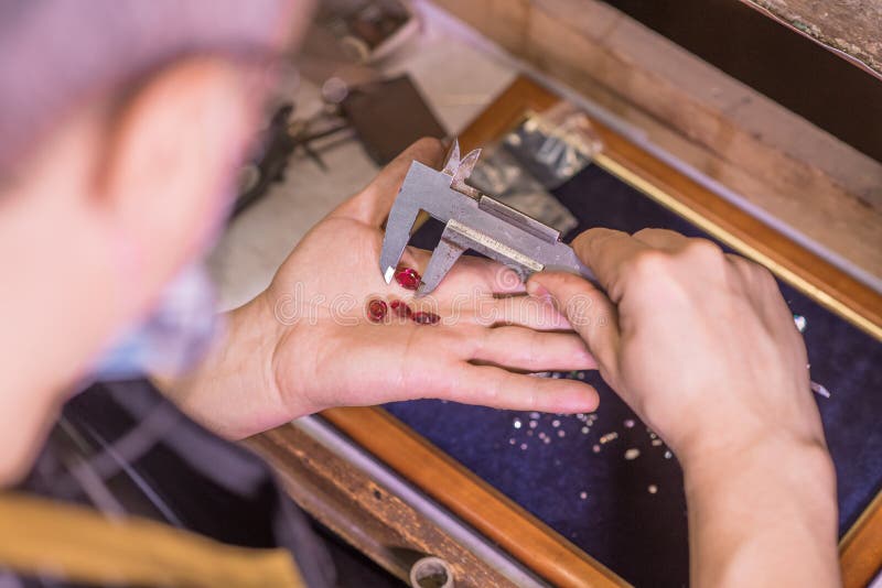 A Man Jeweler Makes an Accurate Measurement of a Gem Using a Caliper ...