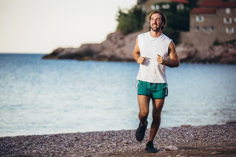 Man Jogging on Beach. Male Runner Training Outside Working Out Stock ...